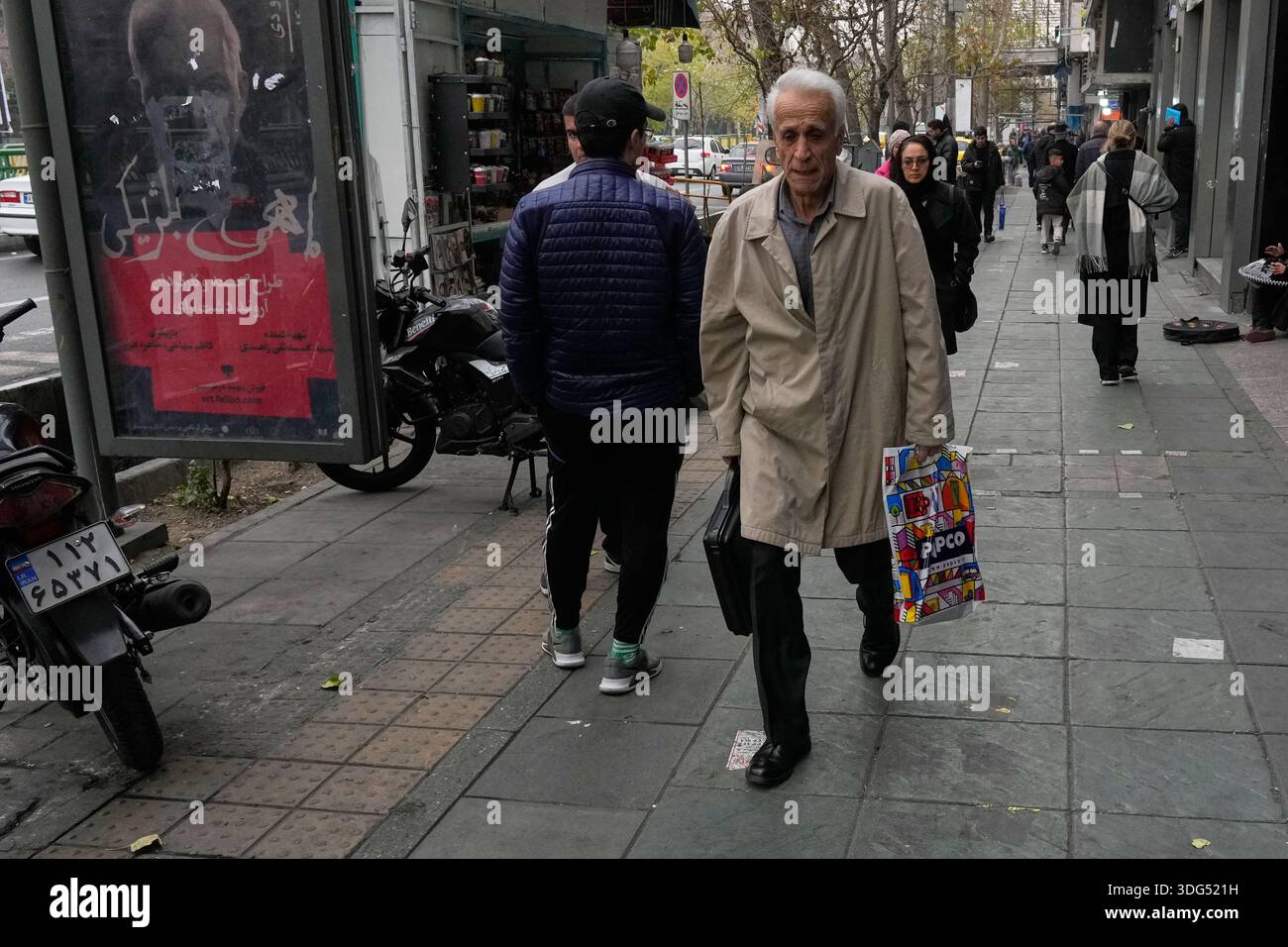 People walk on a sidewalk in downtown Tehran, Iran, Thursday, Jan. 15 ...