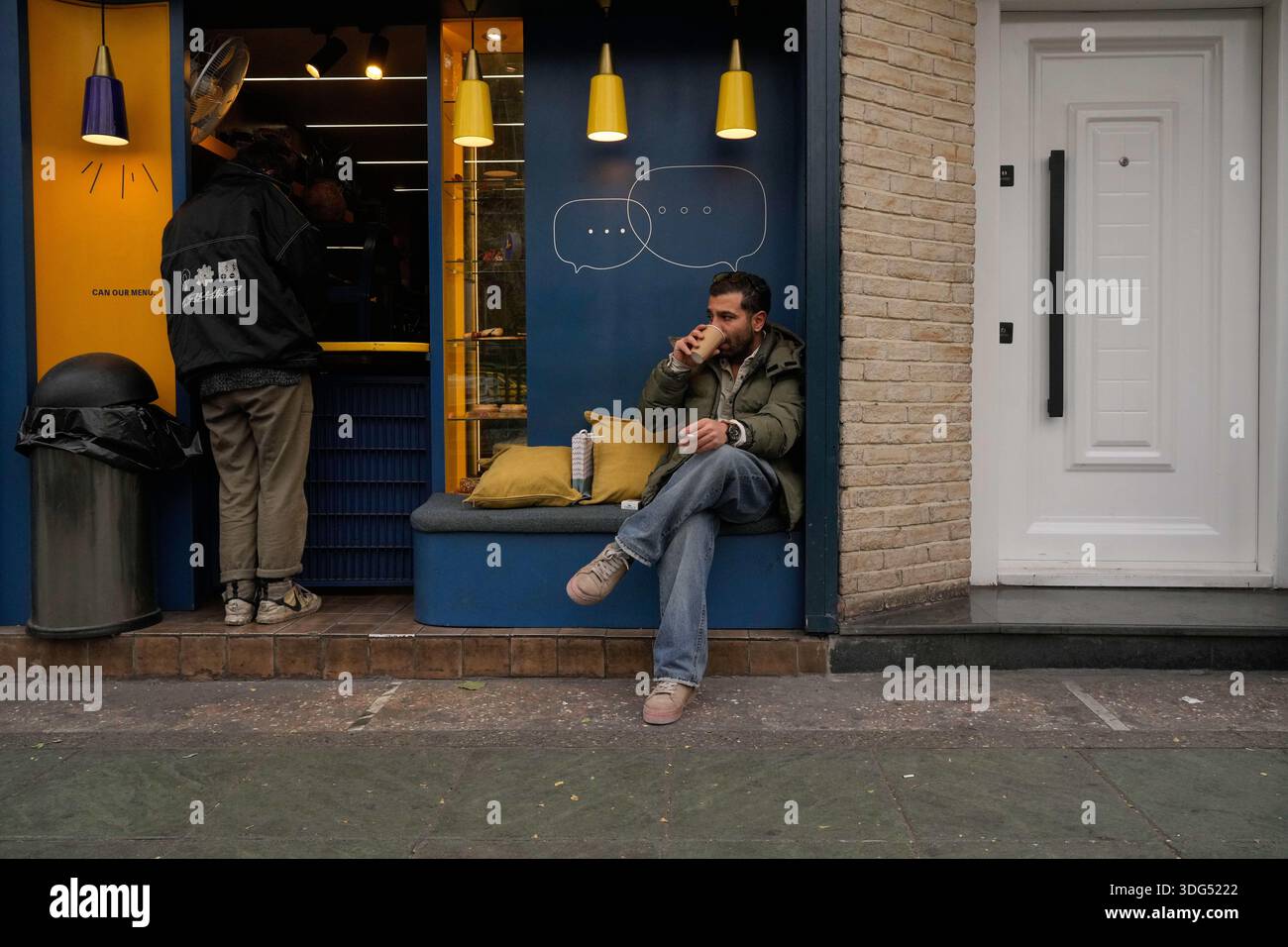 A man drinks coffee at a cafe in downtown Tehran, Iran, Thursday, Jan ...