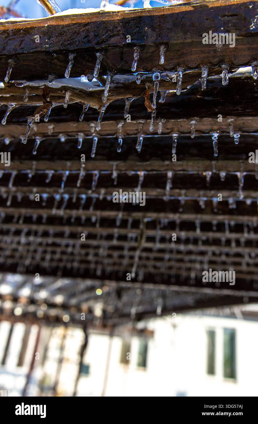 Icicles hang on the roof in winter. Selective focus. nature Stock Photo ...