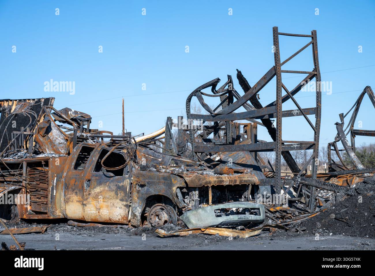 Destruction of vehicle and structure after fire at industrial site in ...