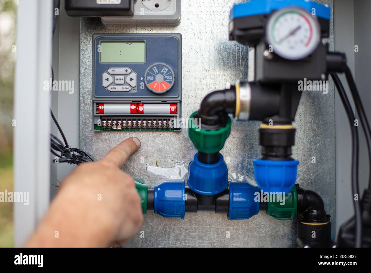 A persons finger pointing at the terminal connections of an automatic ...