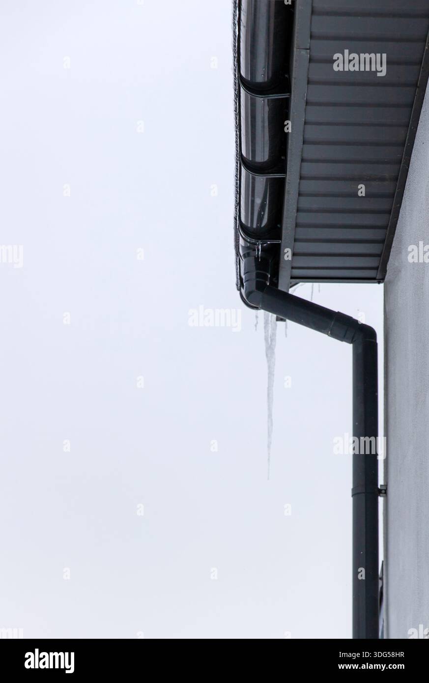 Icicles hang on the roof in winter. Selective focus. nature Stock Photo ...
