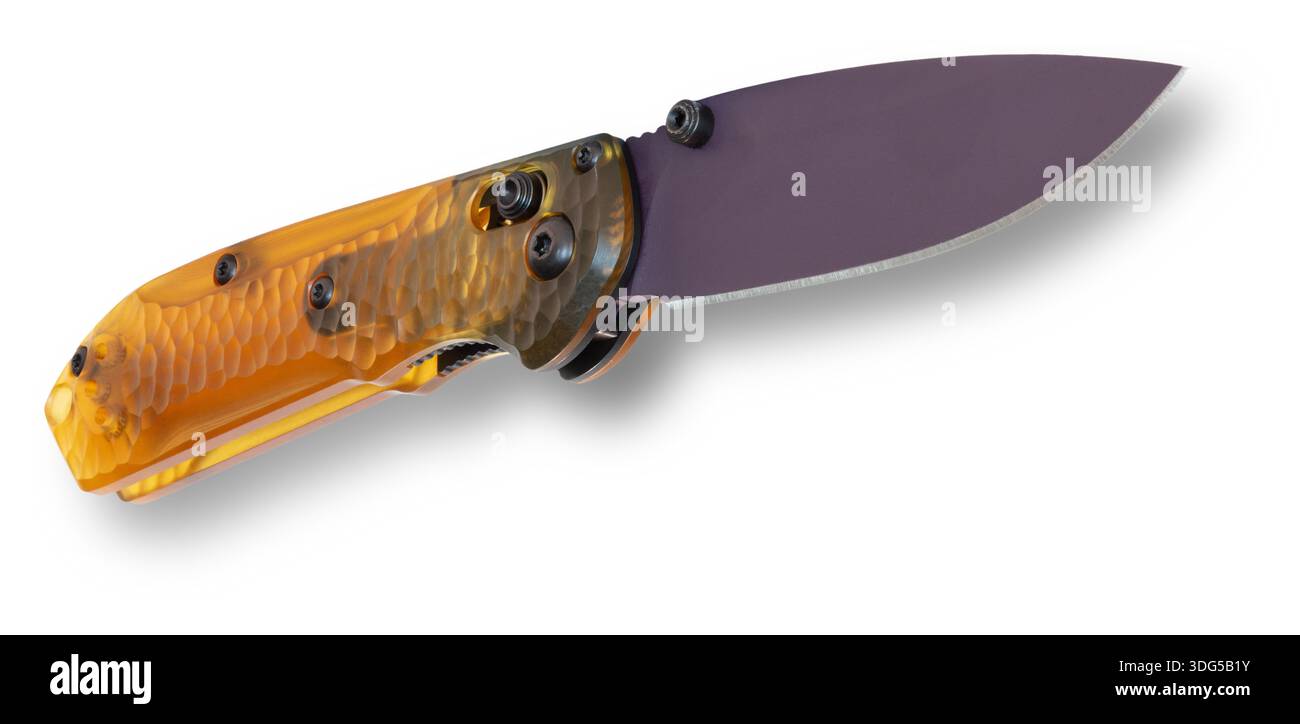 Yellow handled folding knife with the blade extended toward the camera ...