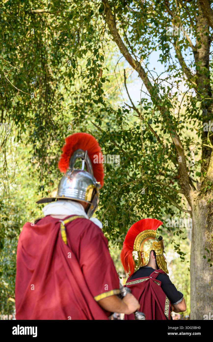 6. Back view of two Roman centurions wearing helmets with red crests ...