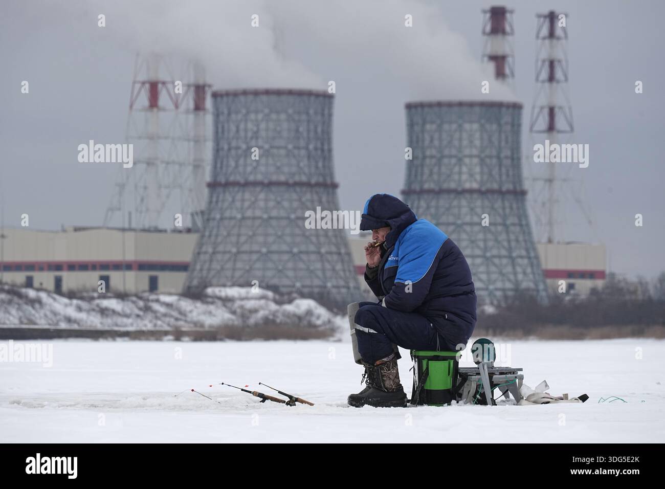 A man fishes on the ice of the Gulf of Finland in St. Petersburg ...