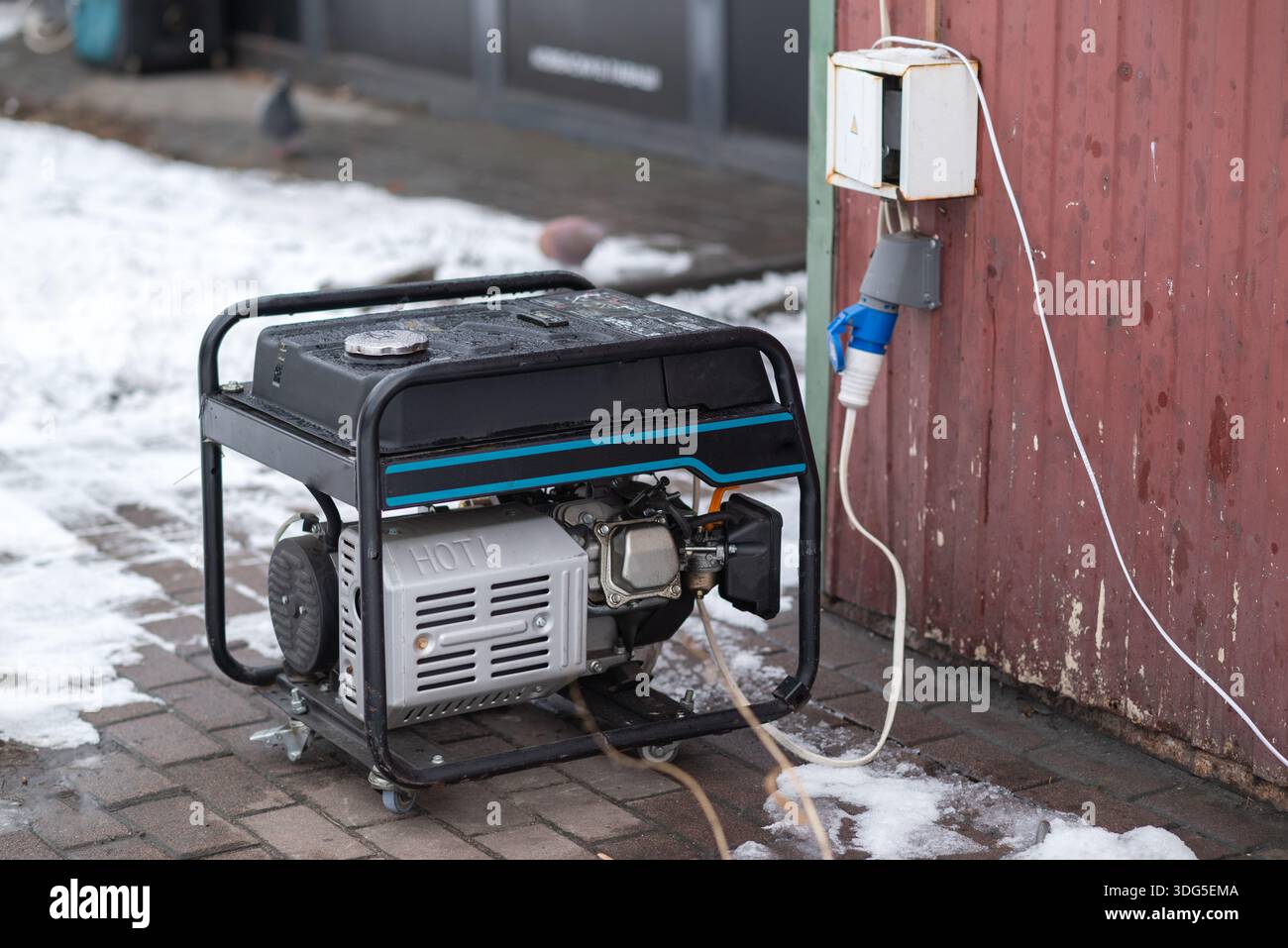 Portable gas generator providing emergency power supply on a snowy city ...