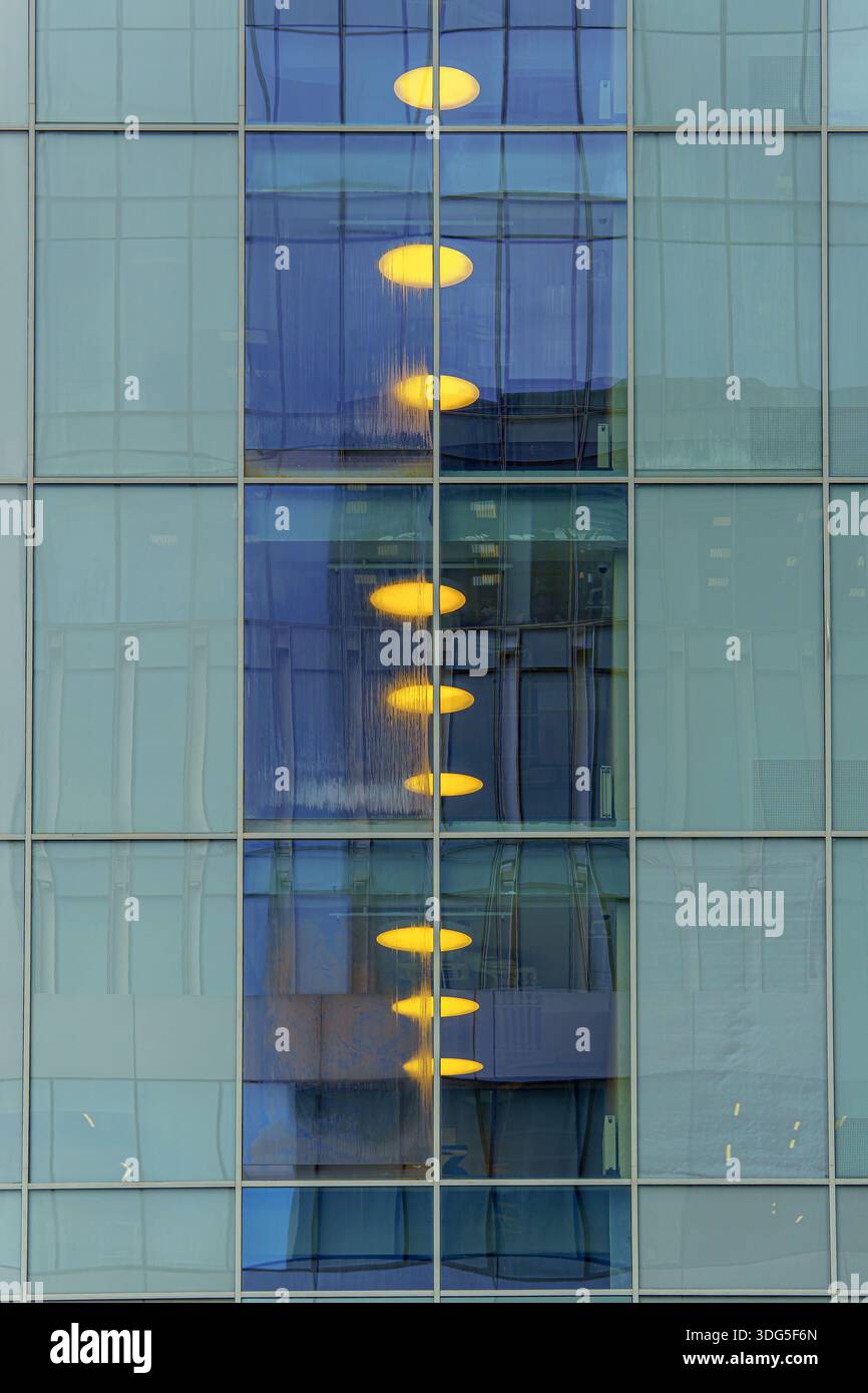 Reflections of street lights in glass windows create a multilayered ...