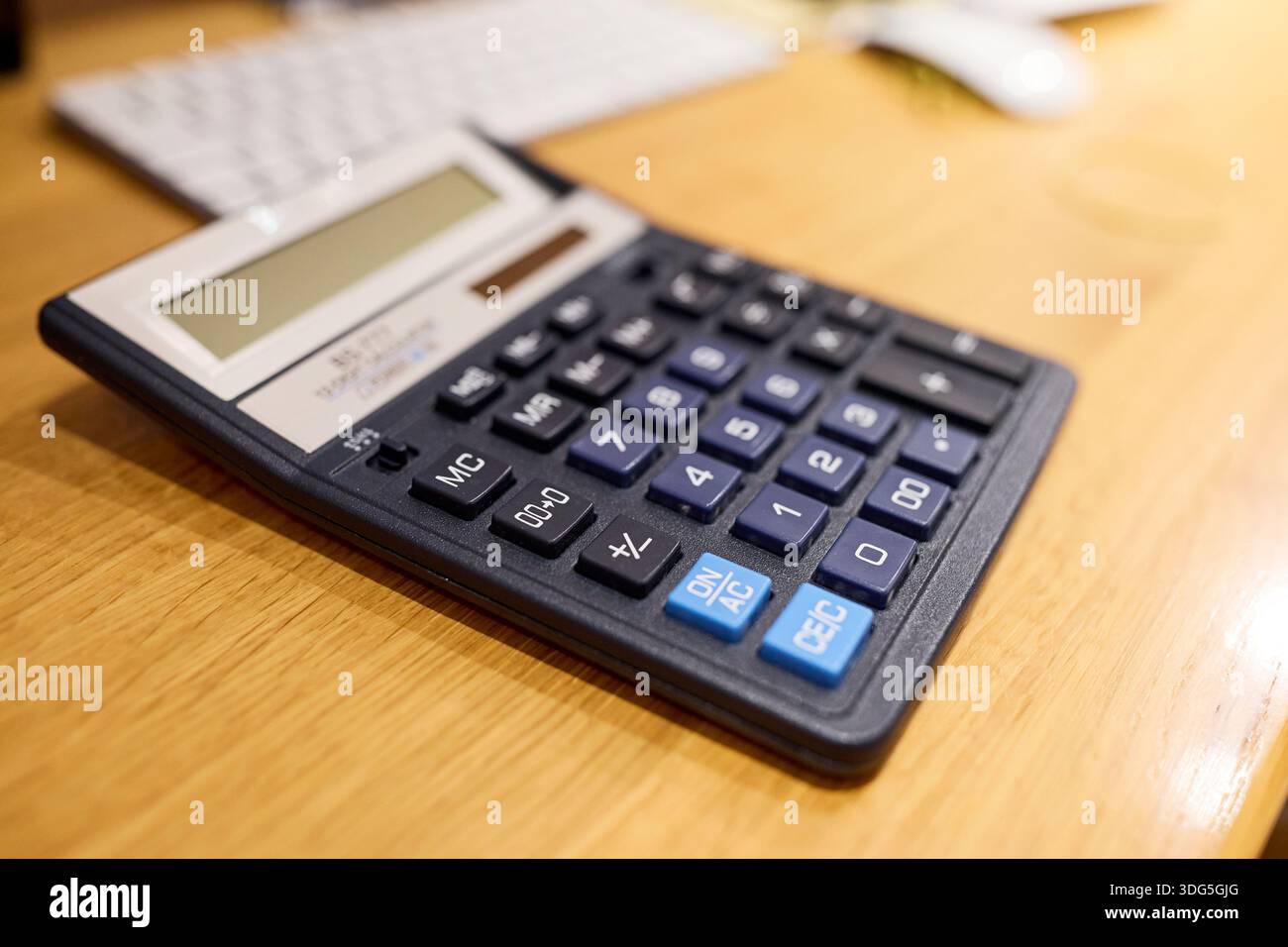 Close-up of a calculator placed on a desk, representing office work ...