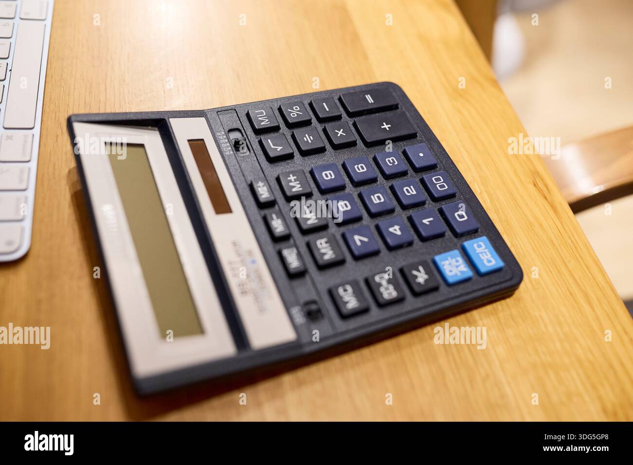 Close-up of a calculator placed on a desk, representing office work ...