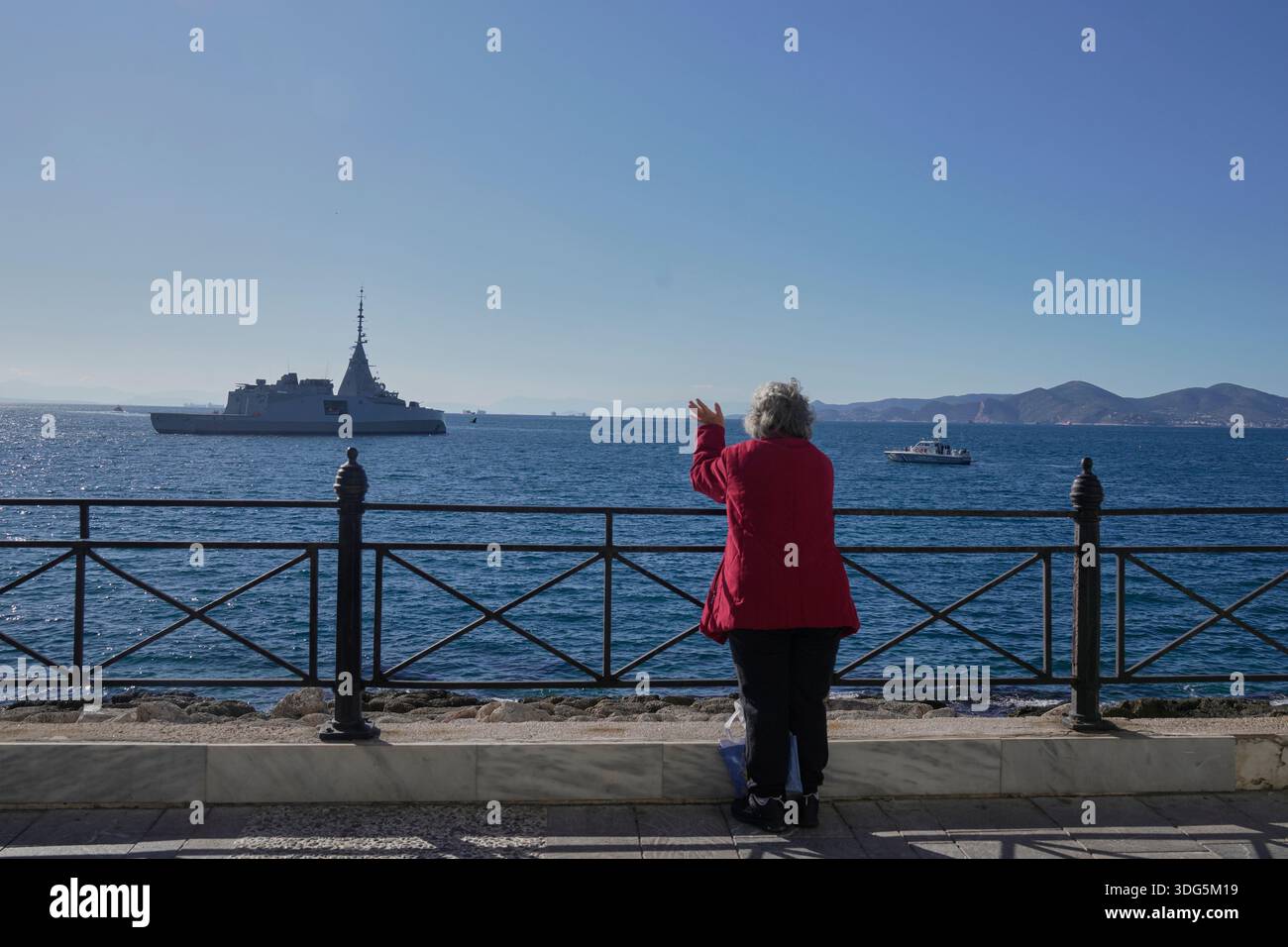 A woman waves to Kimon, the first of four modern French-built frigates ...