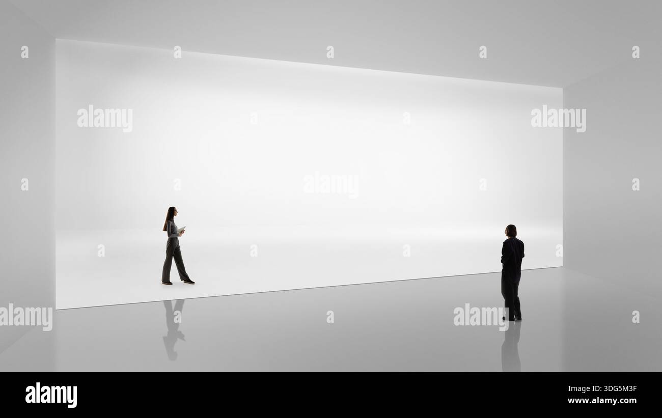 Minimalist artwork with two people facing large white wall Stock Photo ...