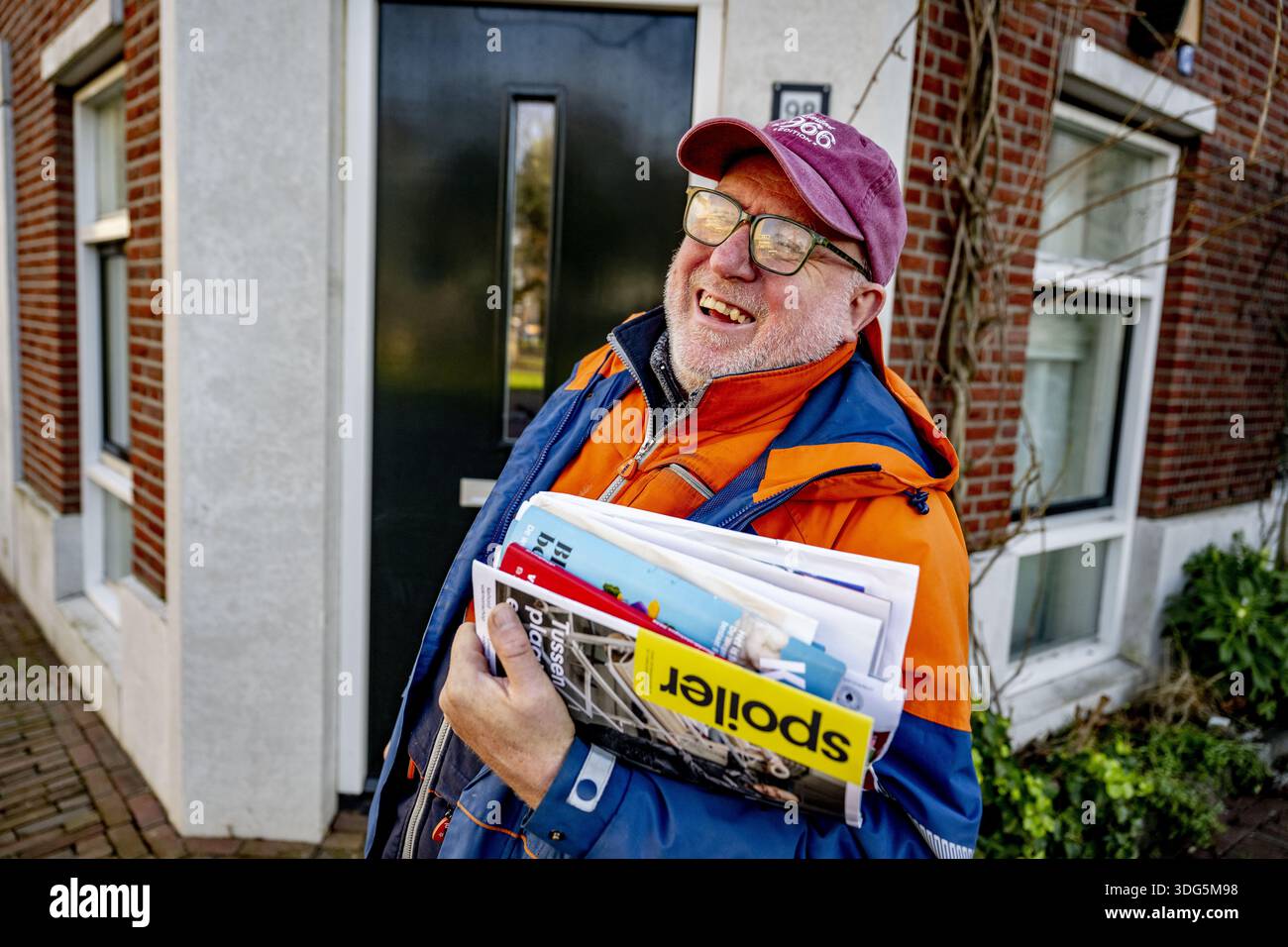 ROTTERDAM - A PostNL mail carrier is delivering letters. ROBIN UTRECHT ...