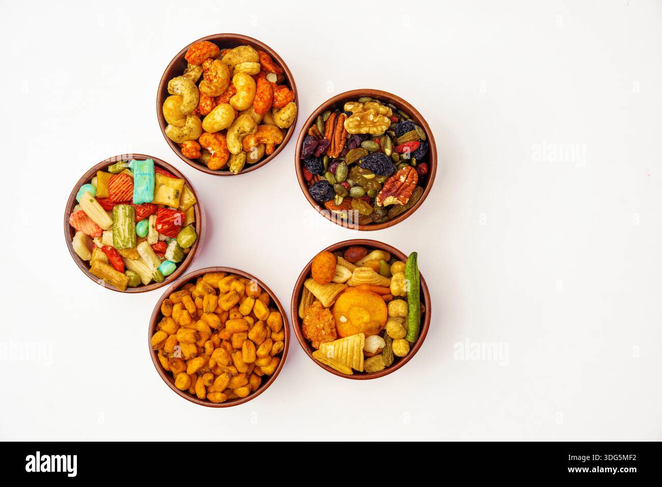 Different types of nuts, seeds and dried fruits on black background ...