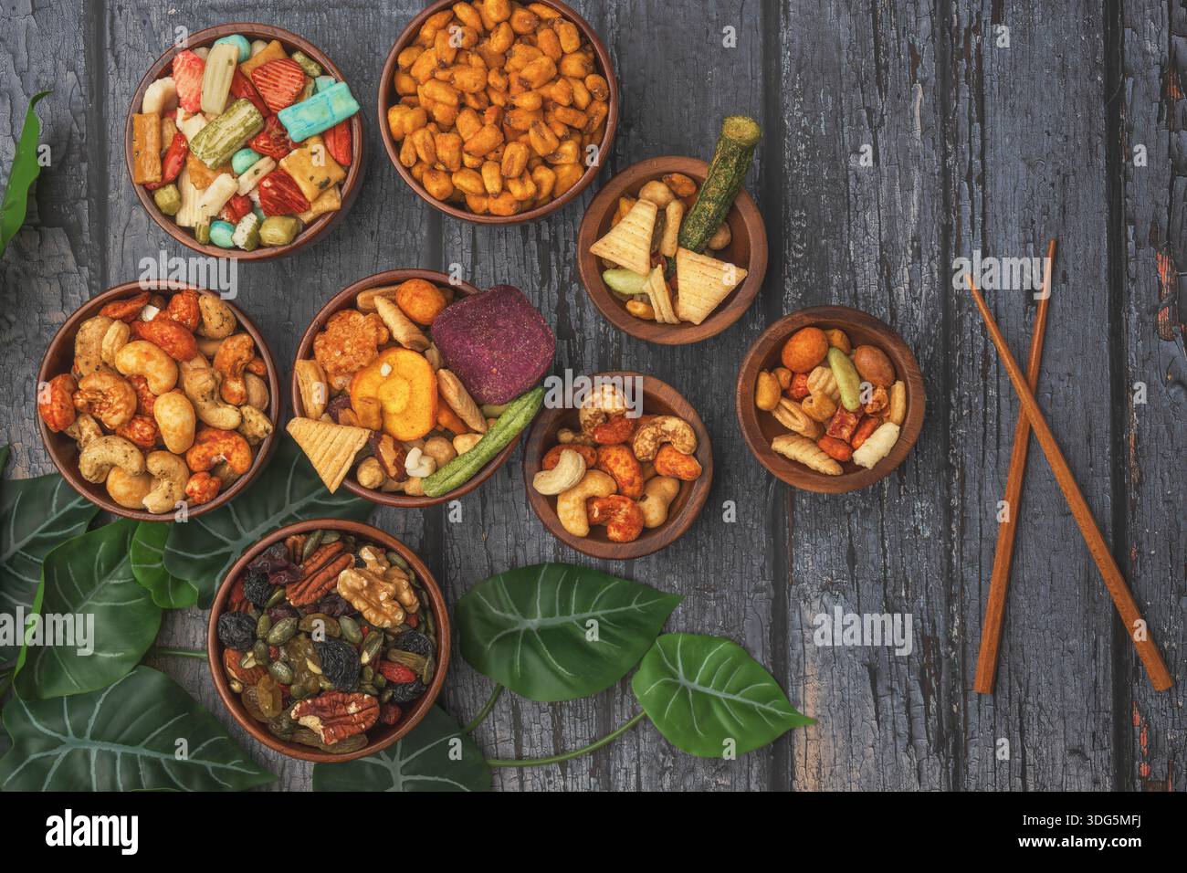 Different types of nuts, seeds and dried fruits on black background ...