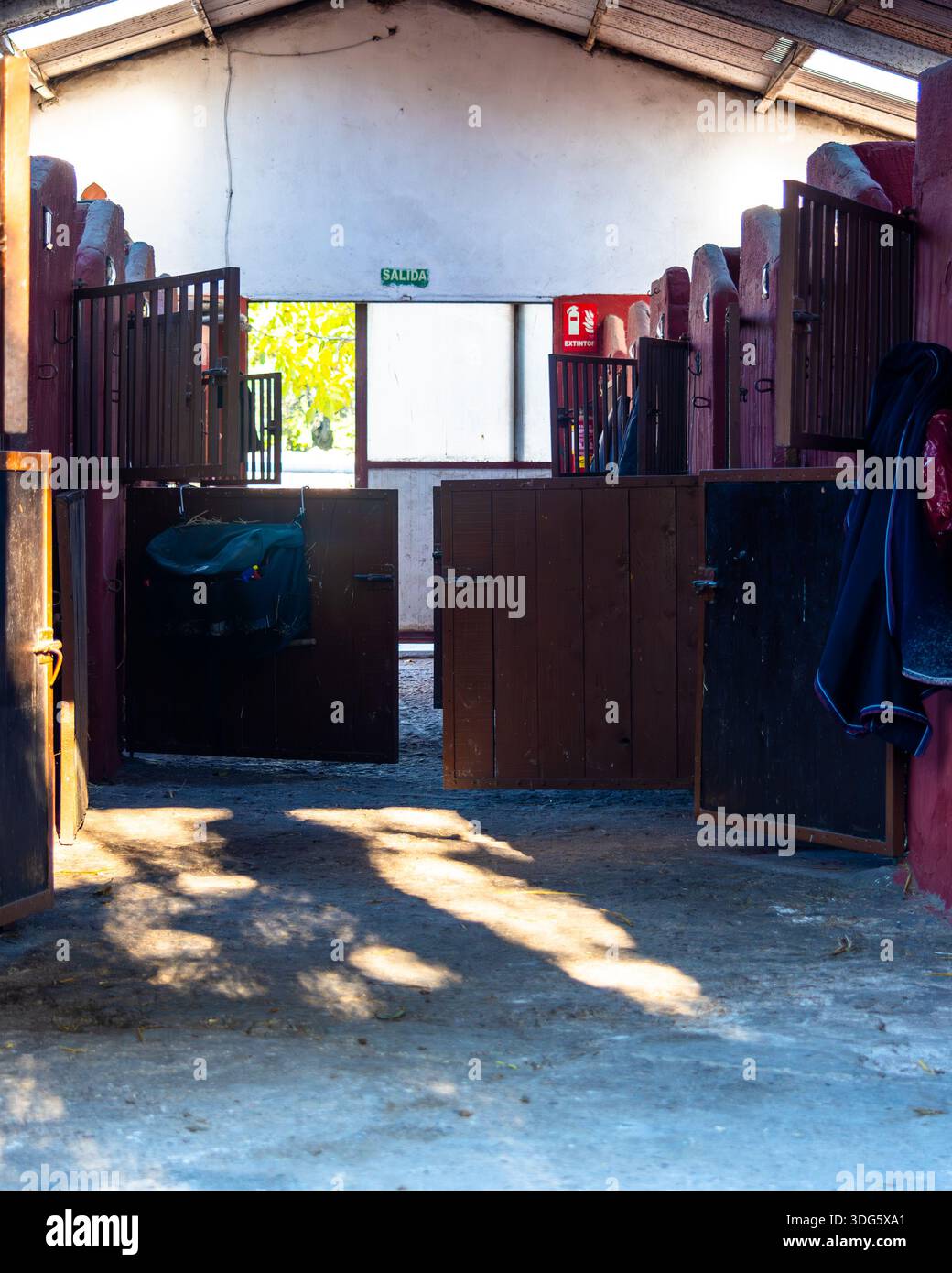 Interior of a Horse Stable with Red Painted Stalls and Wooden Doors ...