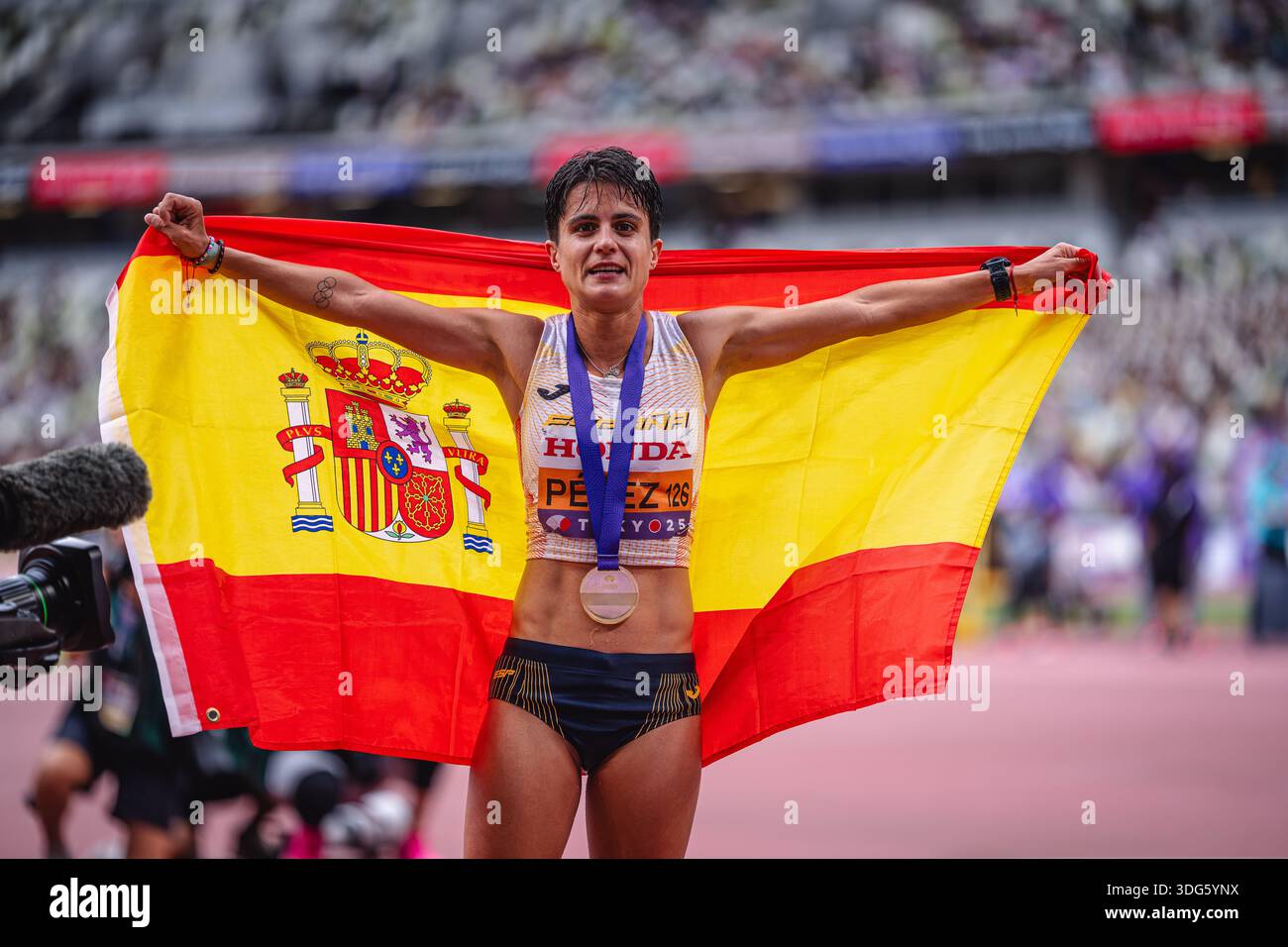 Maria Perez celebrating her victory with her country's flag at the 2025 ...