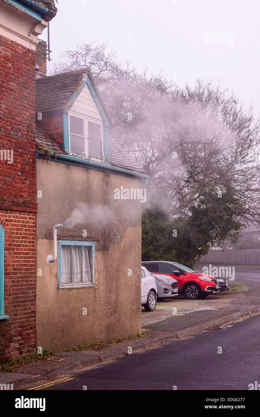 Fumes billowing from a gas boiler flue in cold weather in winter, UK ...