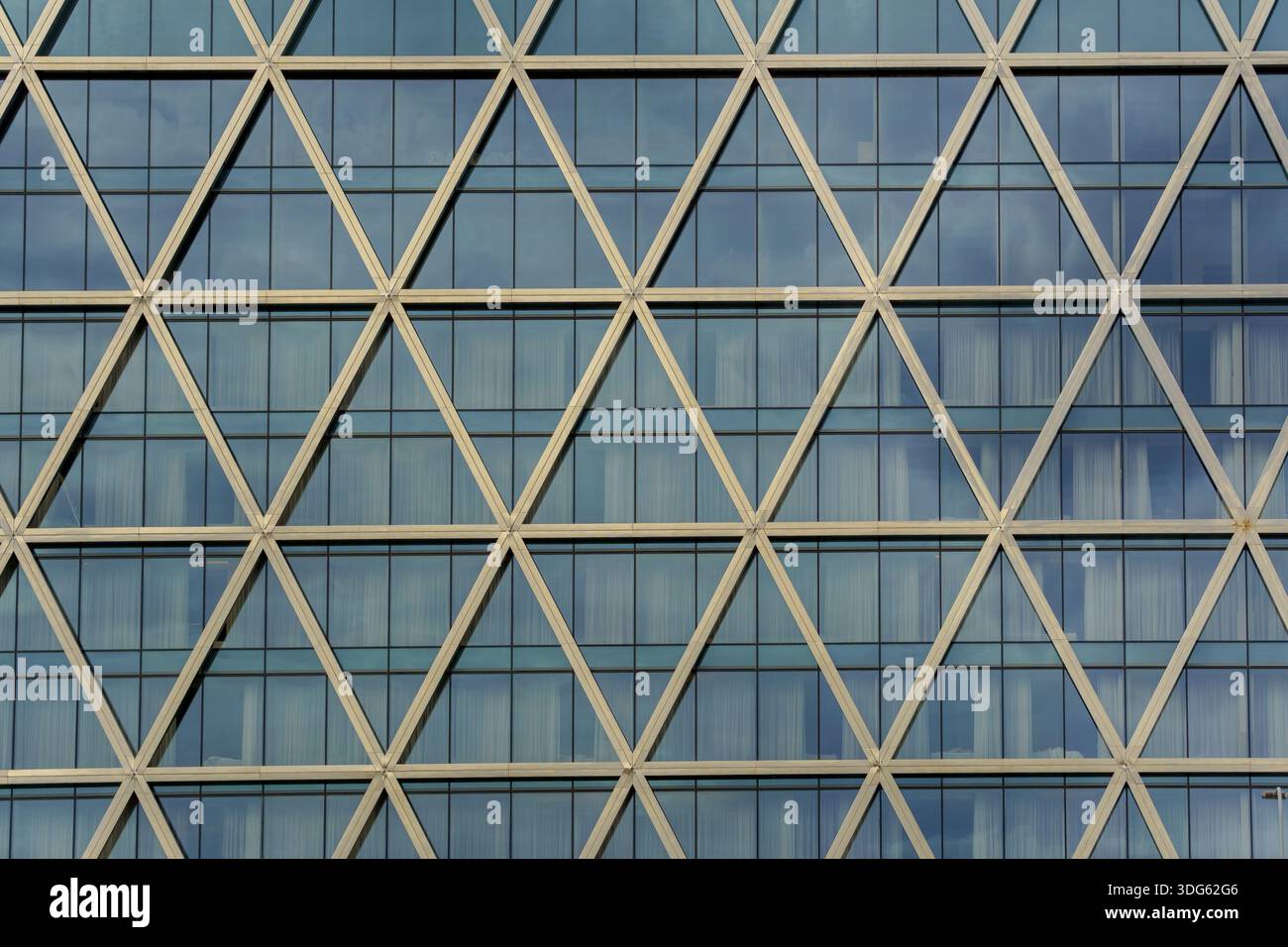 A building facade features a repeating pattern of triangular metal ...