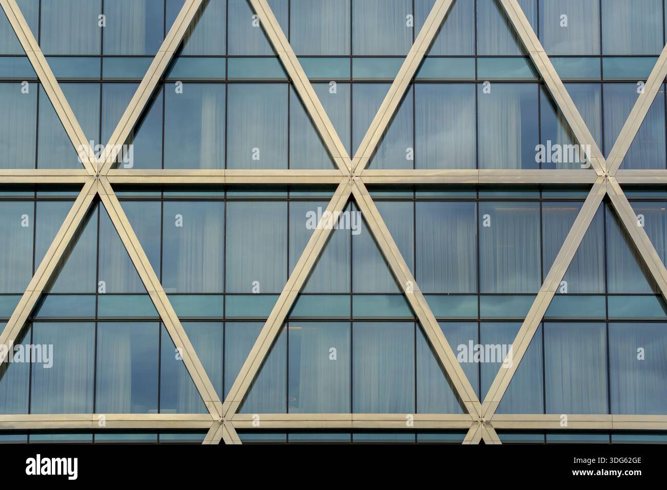 A building facade features a repeating pattern of triangular metal ...