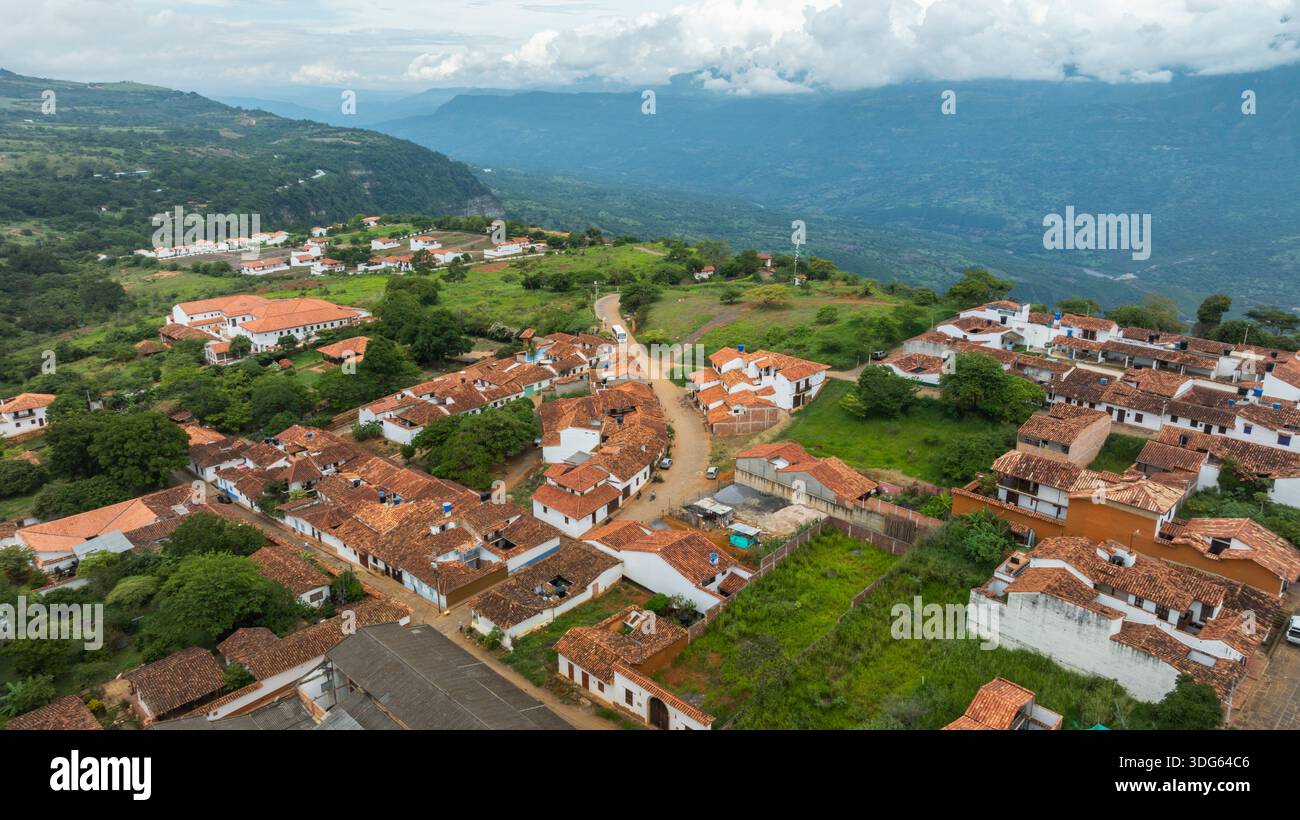 Aerial view of a picturesque village with red rooftops amidst lush ...