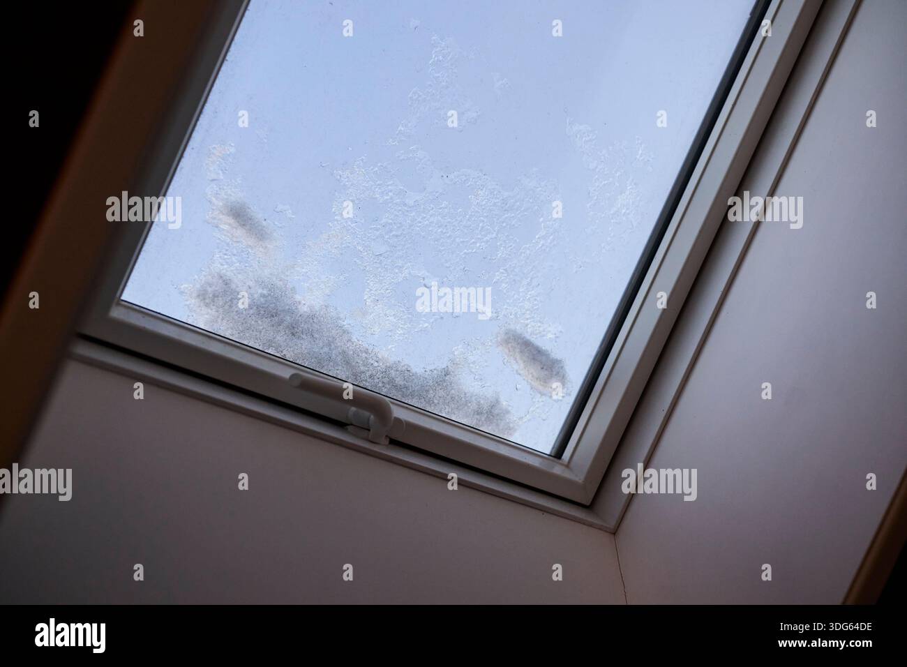 Close-up of a roof window installed in a ceiling, allowing natural ...