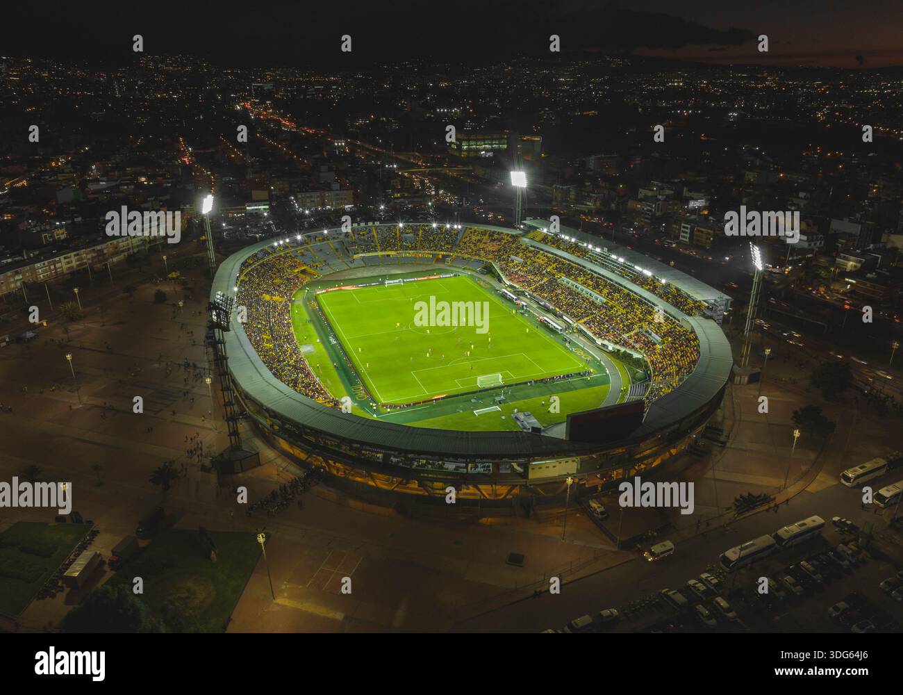 Aerial night view of a brightly lit stadium during a soccer match ...
