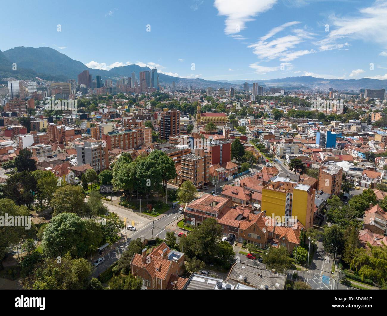 Aerial view of a vibrant cityscape surrounded by mountains under a ...
