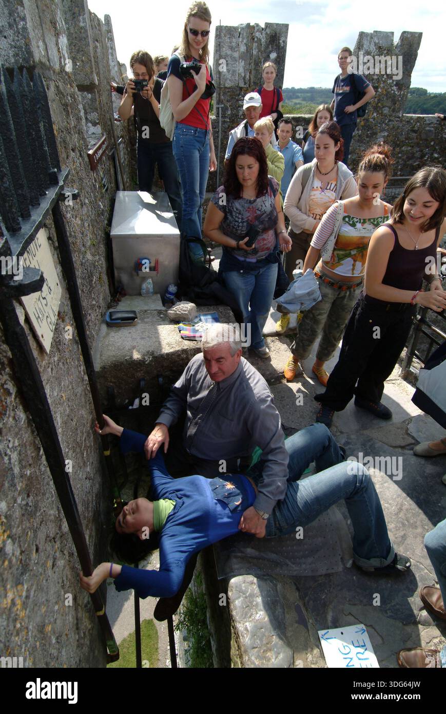 Kissing the Blarney stone on the battlements of Blarney Castle, this ...