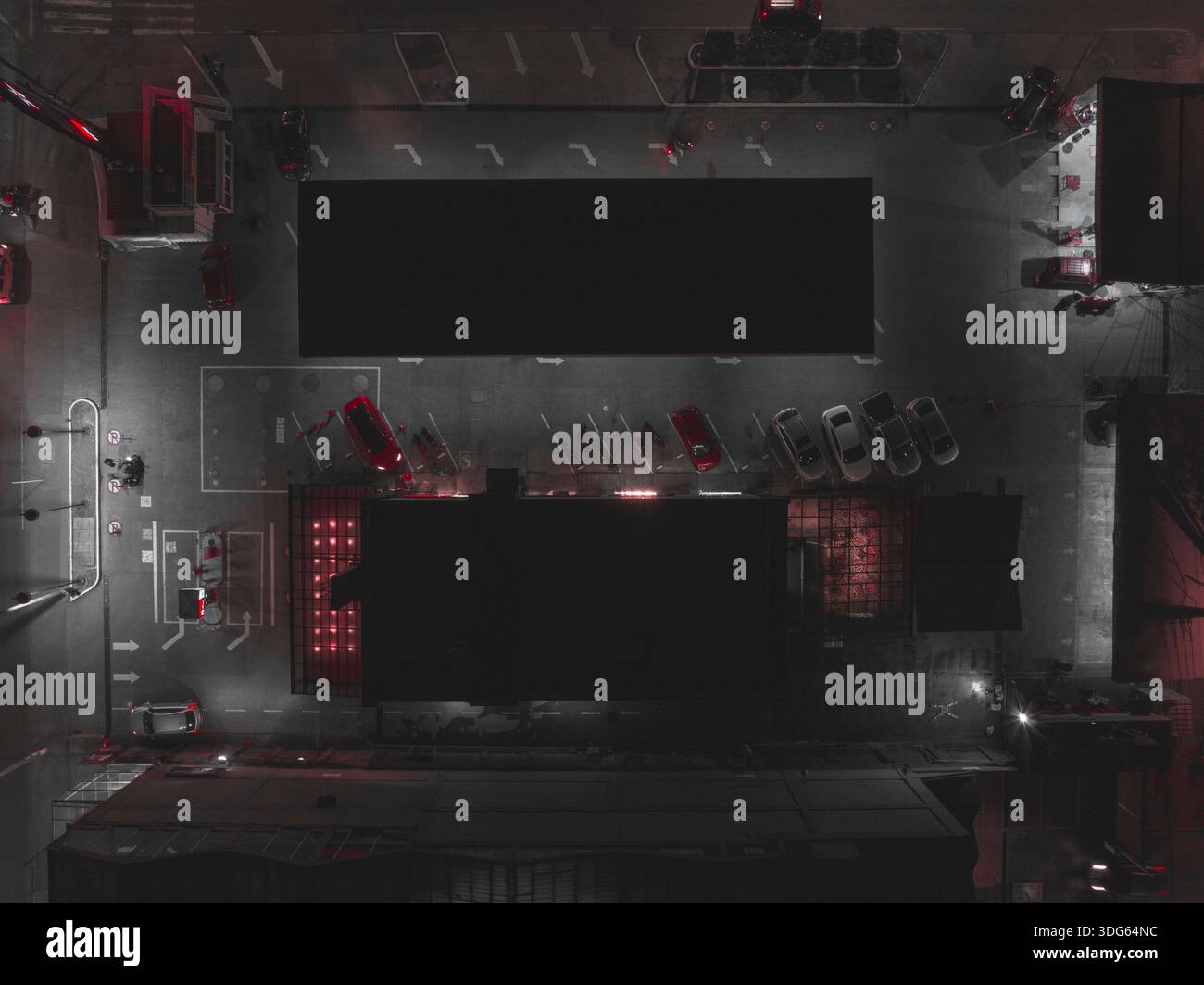 Night aerial view of a parking lot with red and white lights ...