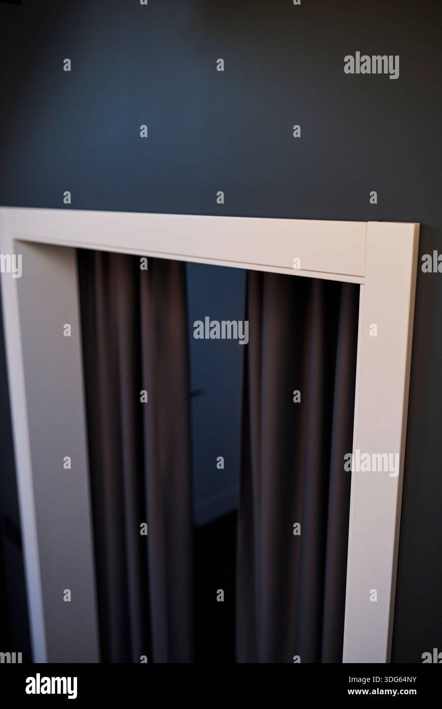 Close-up of a white-painted wooden door frame set against a dark ...