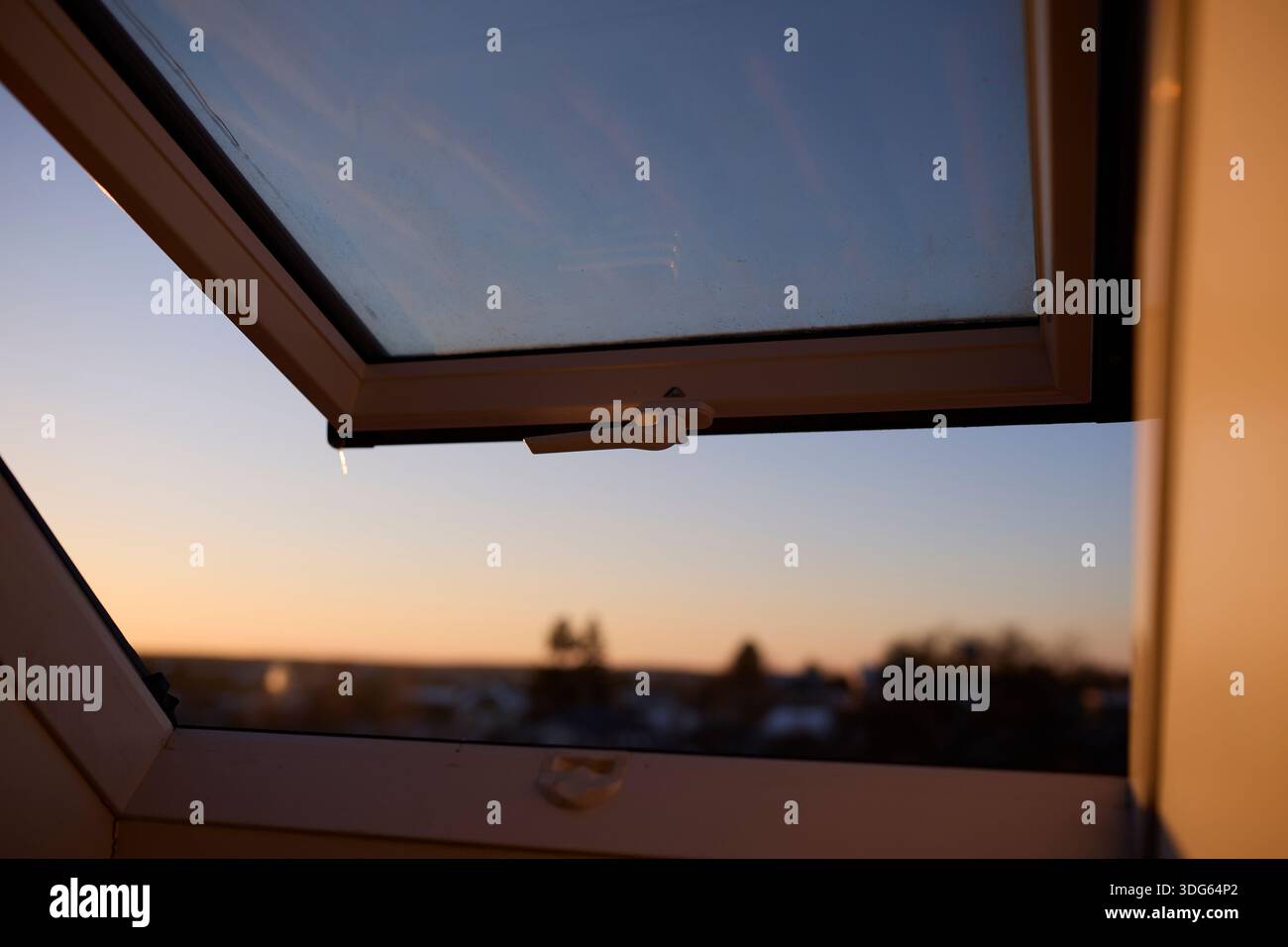 Close-up of a roof window installed in a ceiling, allowing natural ...