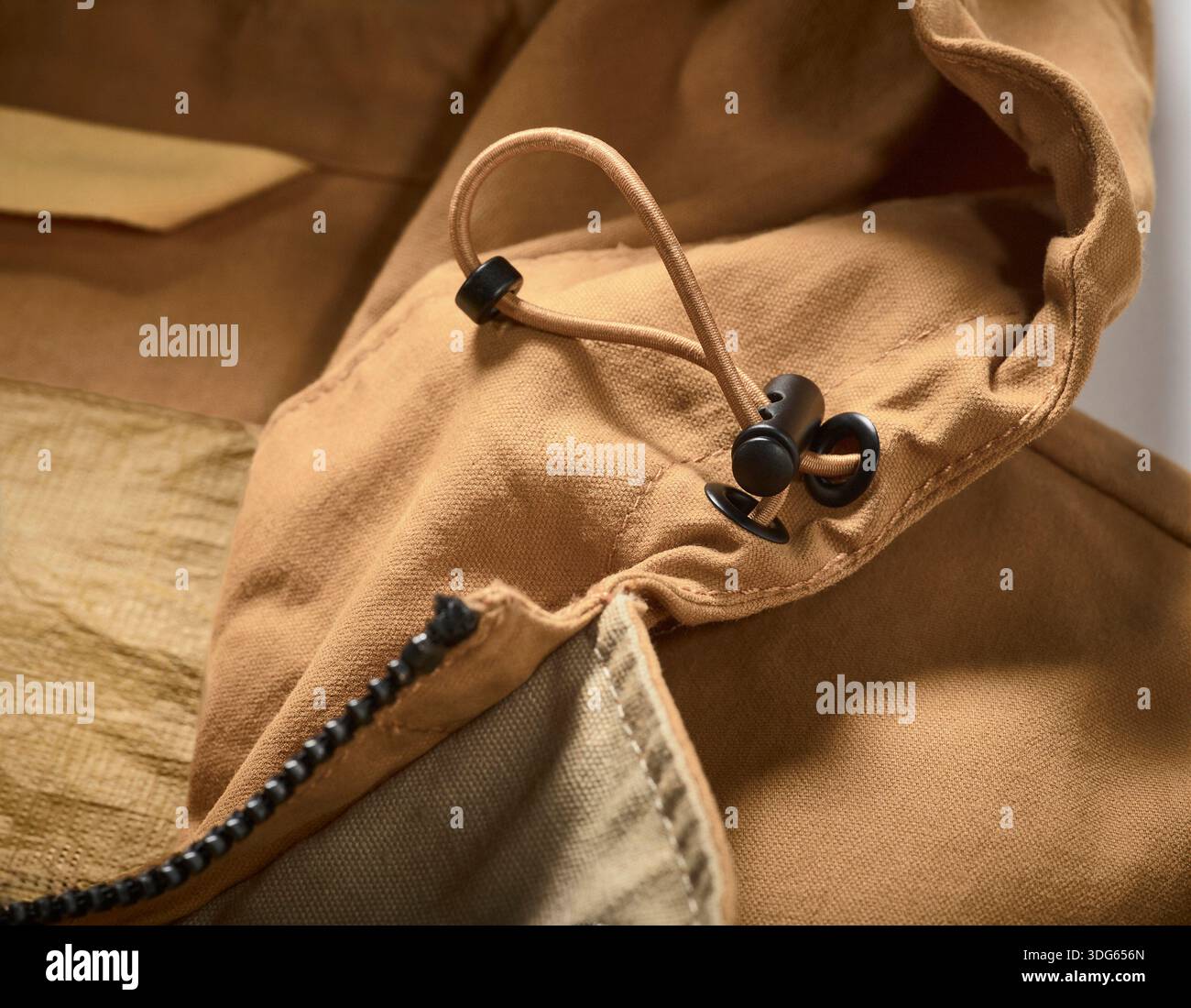 Close-up of a brown jacket's drawstring and zipper details Stock Photo ...