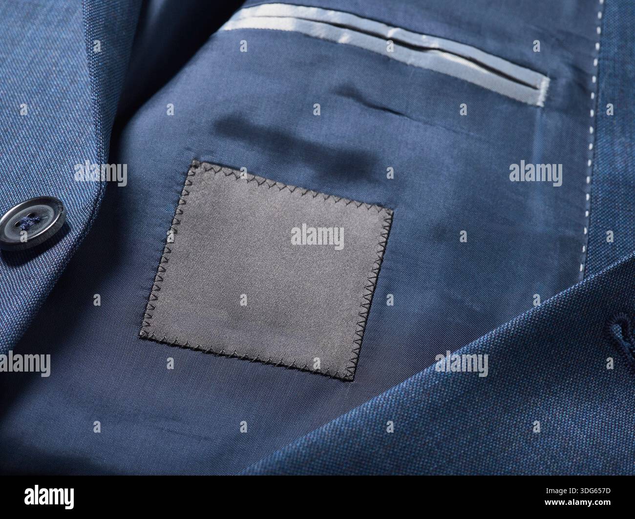 Close-up of a tailored blue suit jacket with a black fabric patch inside Stock Photo - Alamy