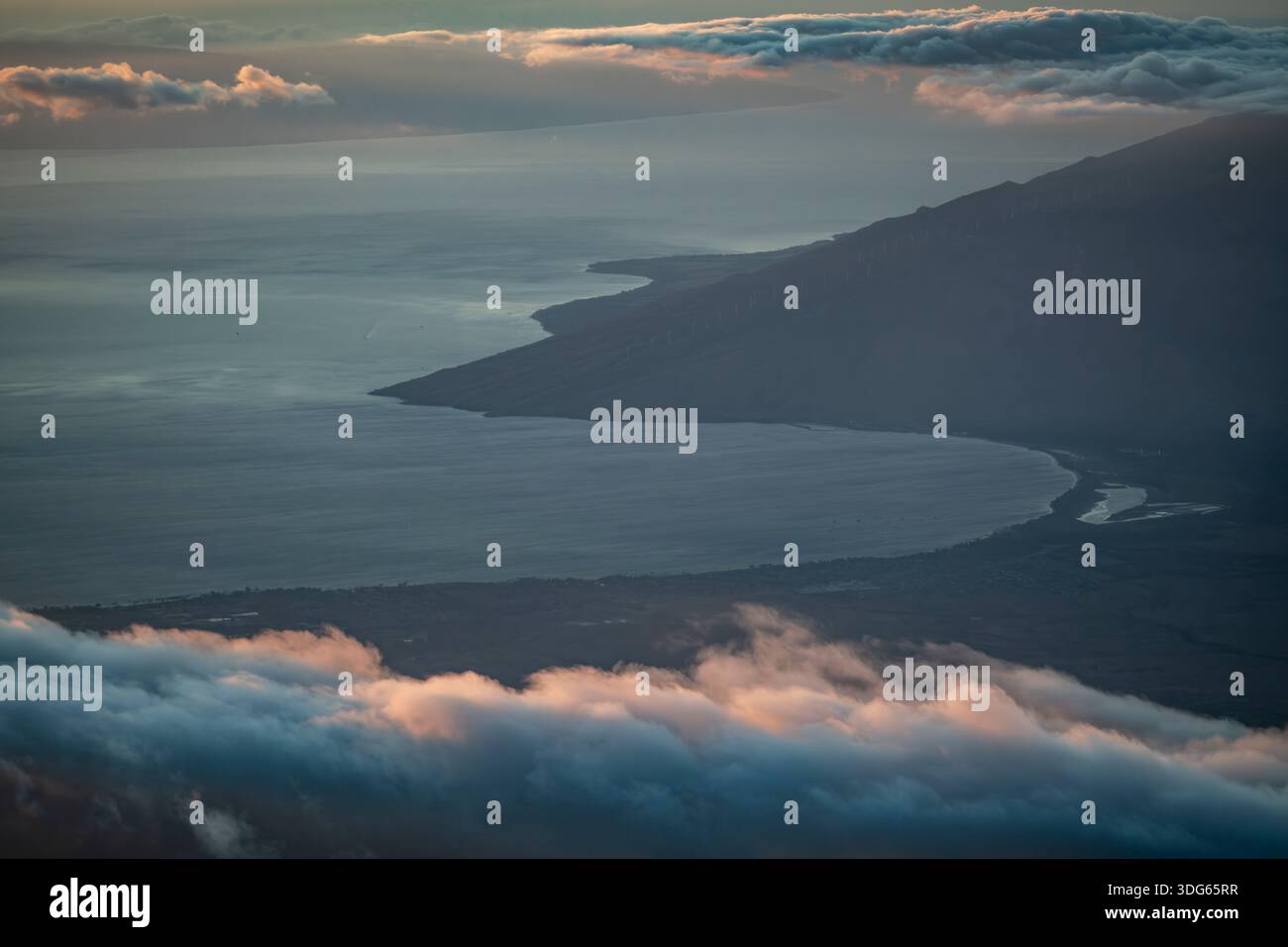 Aerial view of a serene coastline at sunset with clouds and a ...