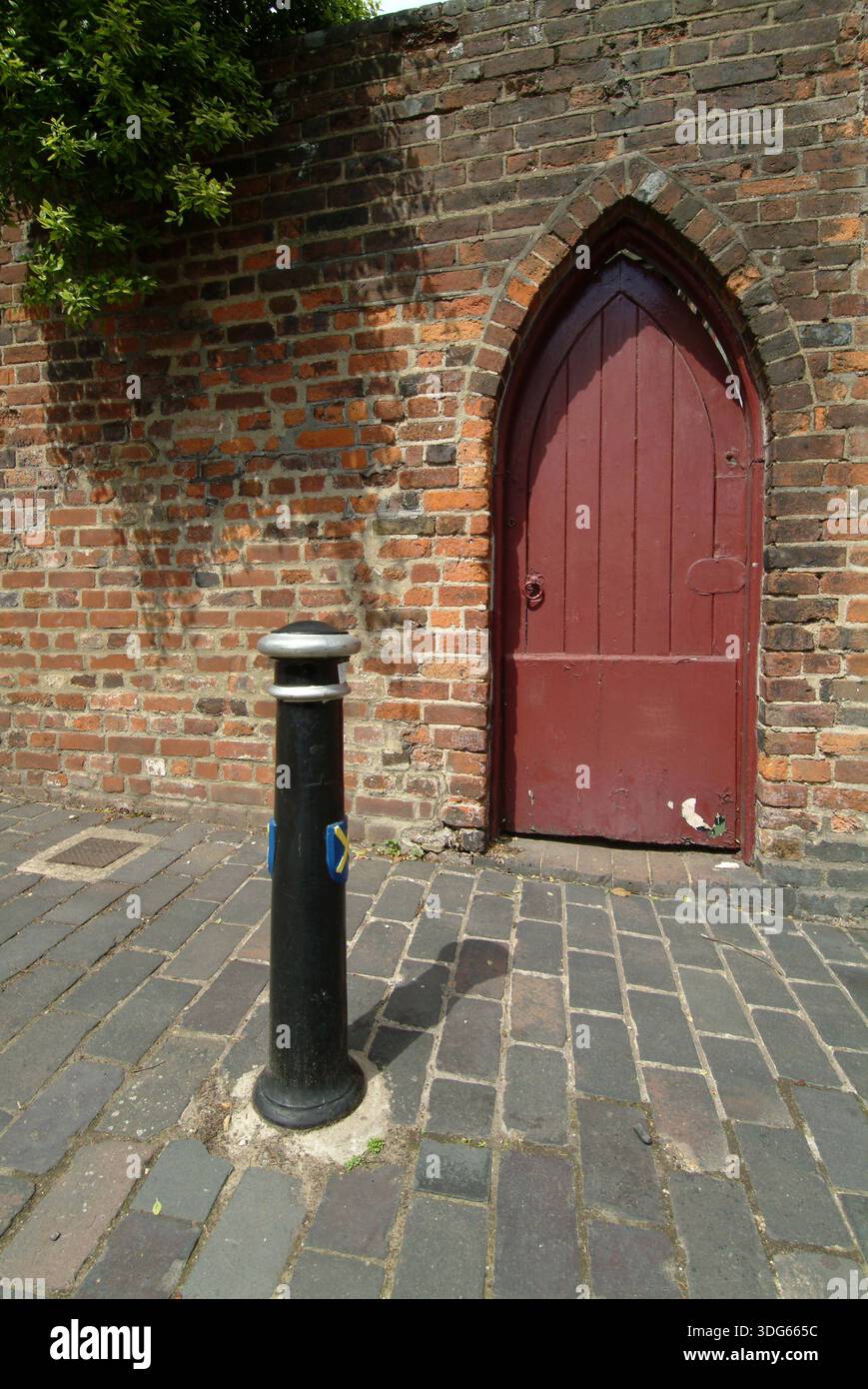 Brown door, bollard, red brick wall. - St. Albans, United Kingdom : May ...
