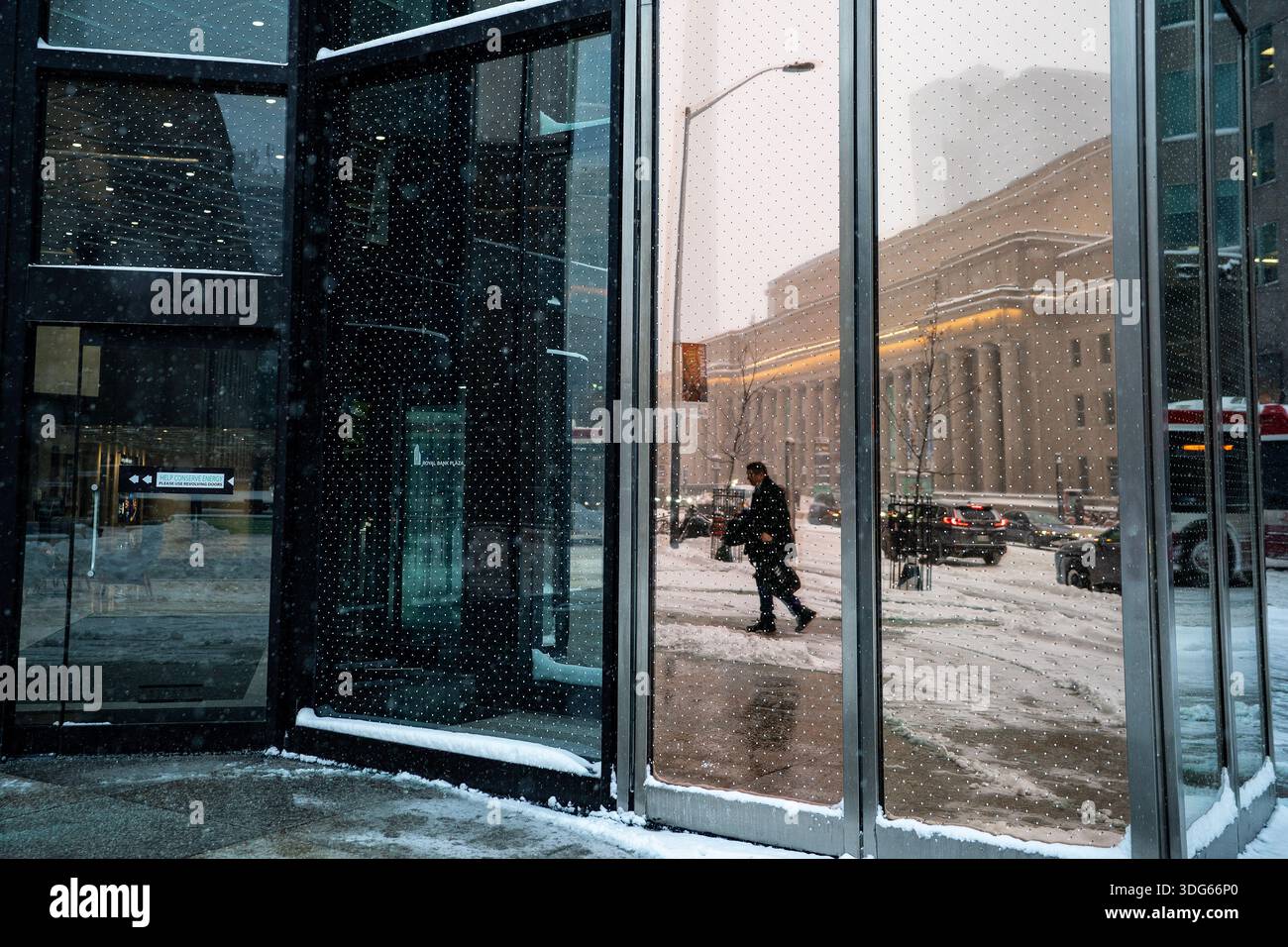 A commuter prepares to enter the Royal Bank Plaza amid heavy snowfall ...