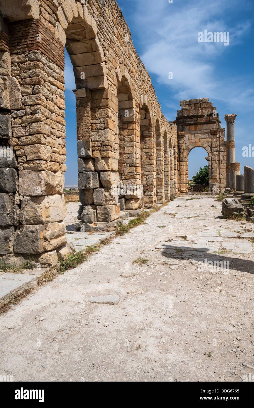Ancient stone ruins with arches under a blue sky, a blend of history ...