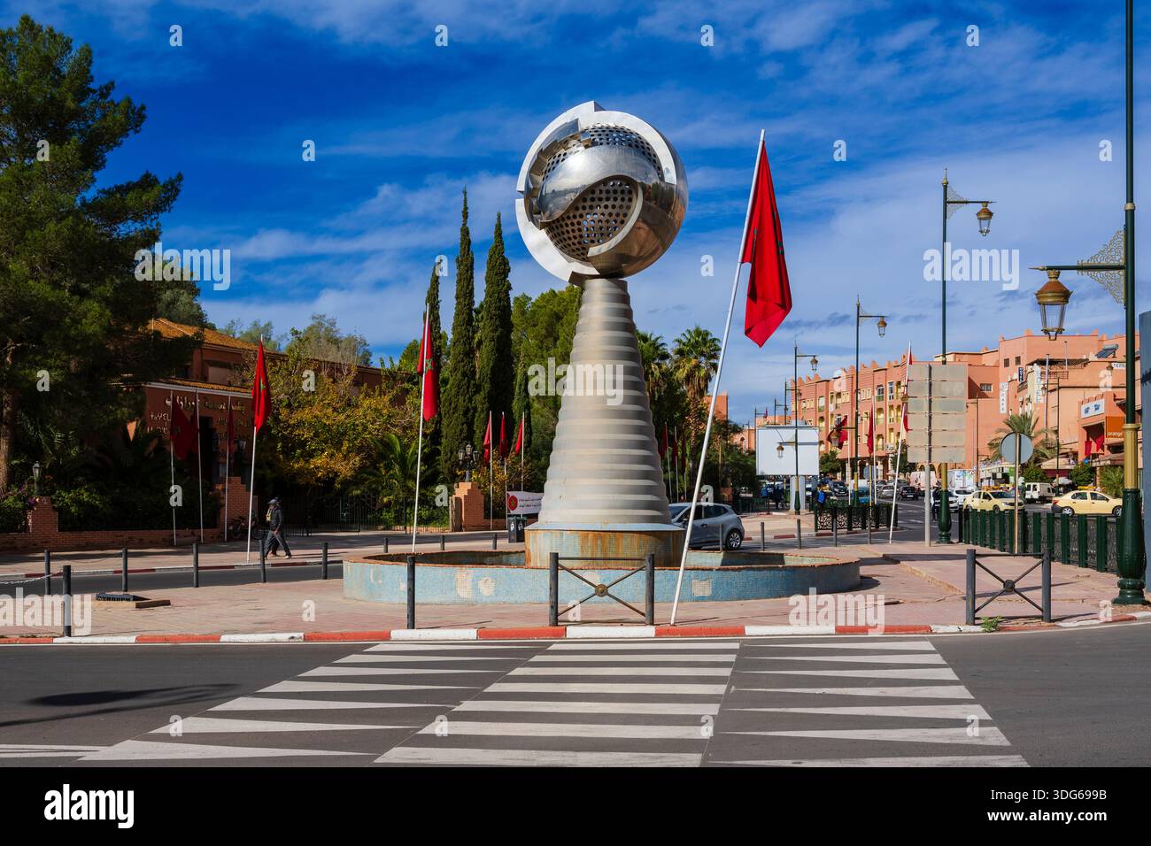 Monument with spiraling silver globe sculpture and flags in urban ...