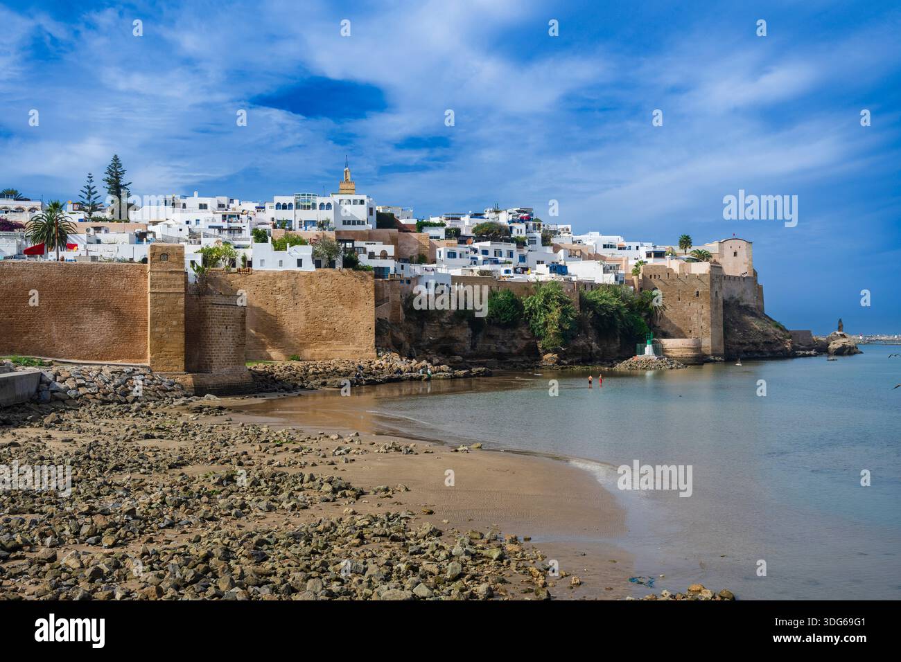 Scenic seaside view of historic white buildings on a hill under a ...
