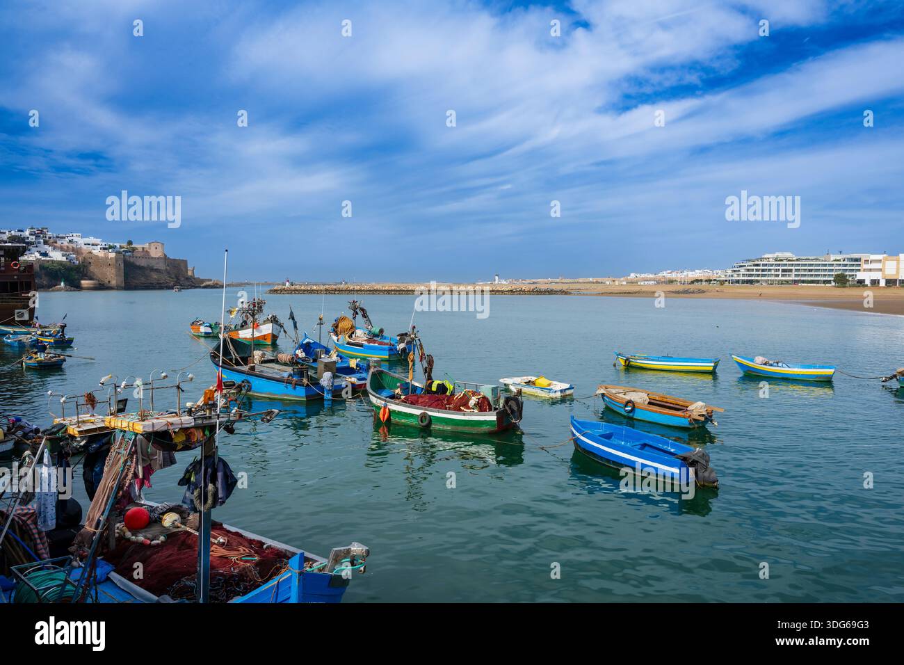 Colorful fishing boats float on a calm blue sea under a vibrant sky ...