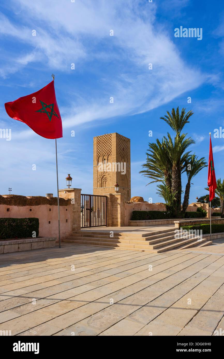 Historic Hassan Tower with Moroccan flags and a vibrant blue sky ...