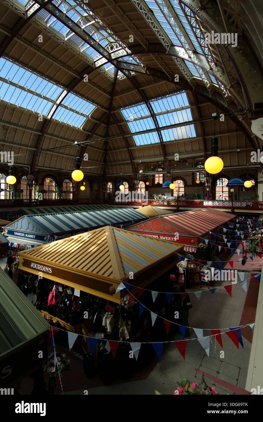 The high ceiling of Derby market hall towers above the trader's stalls ...
