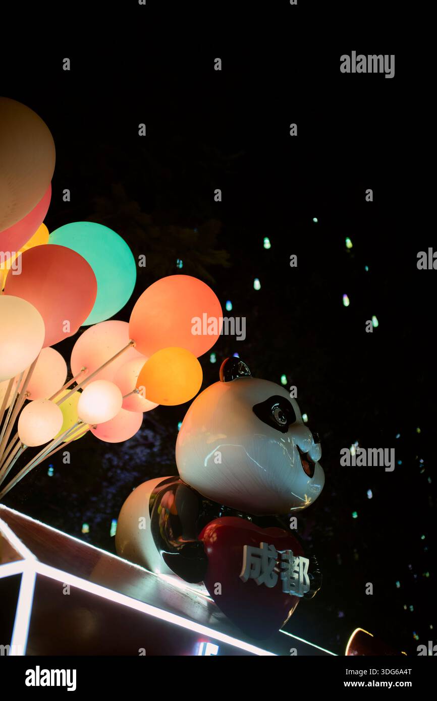 A playful panda figure with colorful balloons against a dark, starry ...
