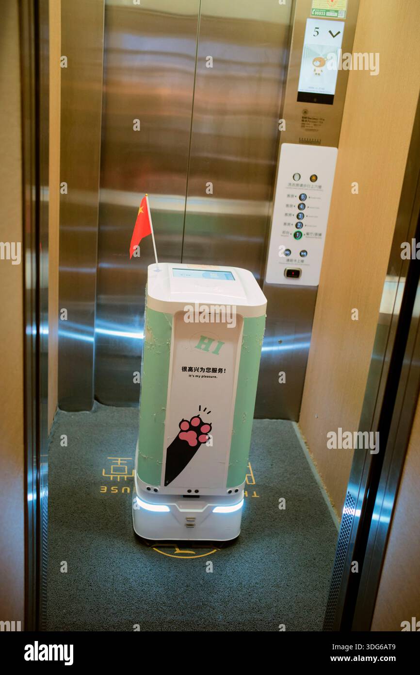 Delivery robot with a small flag waiting in an elevator. Chengdu ...