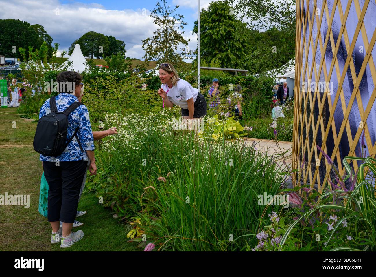 Legacy Garden (woman in conversation with event visitors, volunteer ...