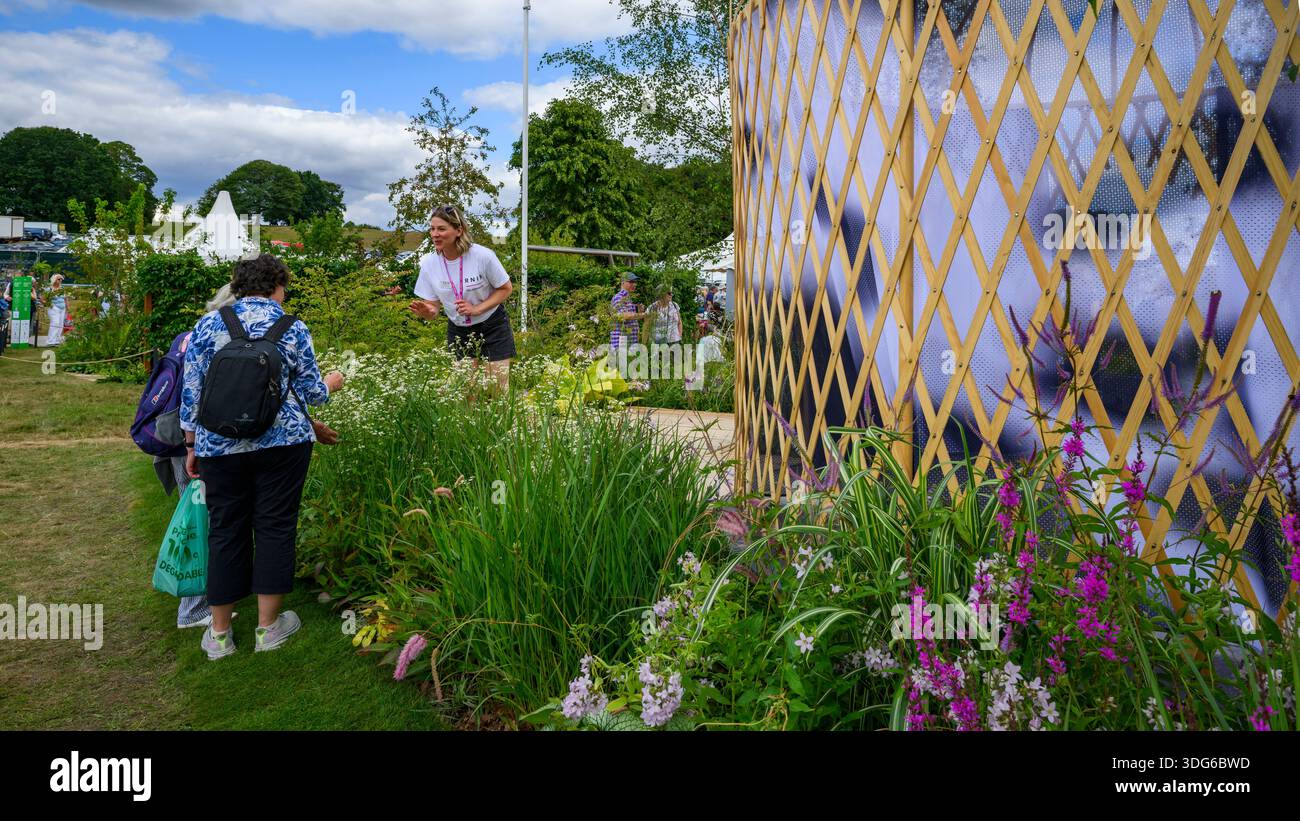Legacy Garden (woman in conversation with event visitors, volunteer ...