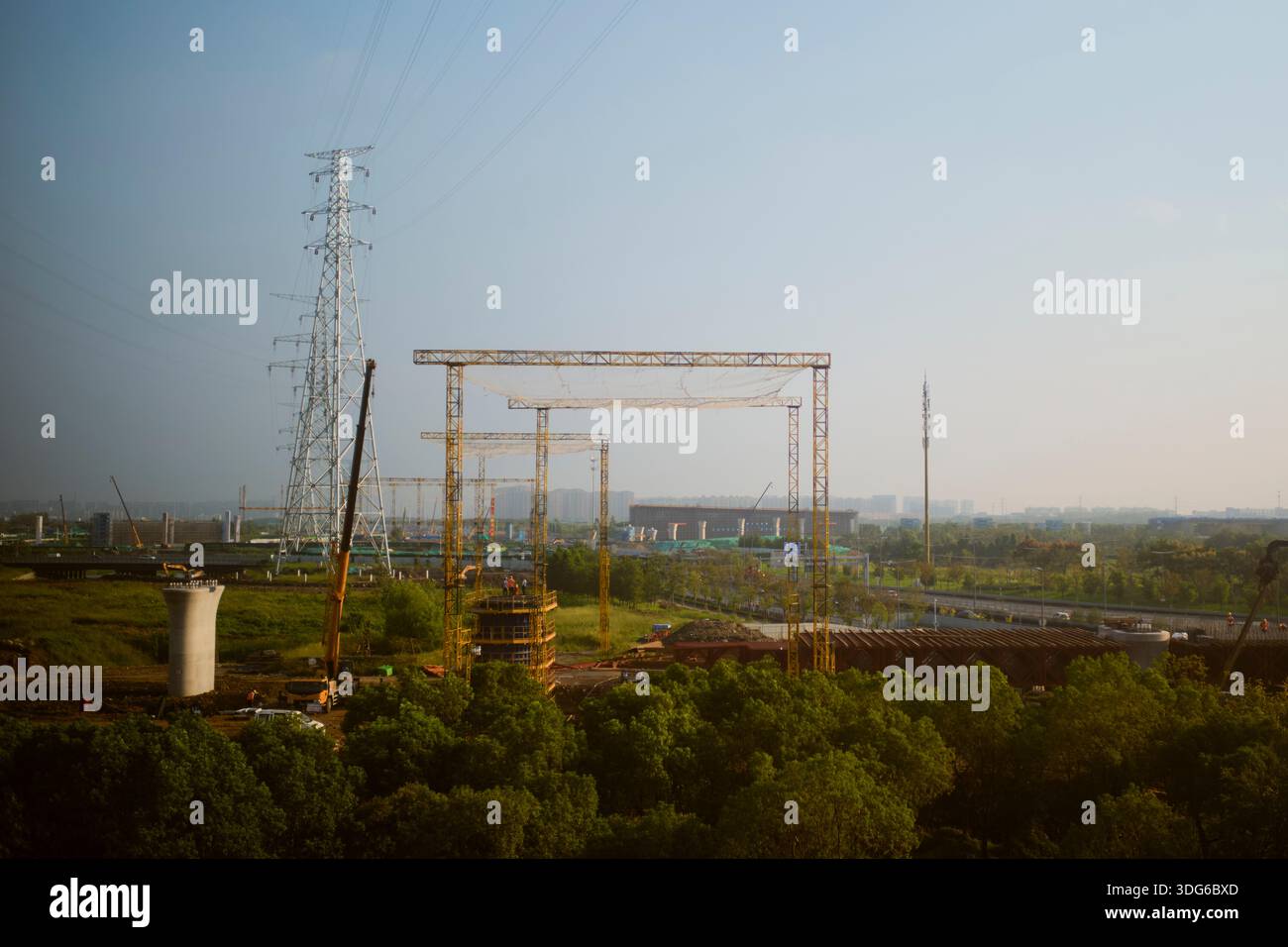 Construction site with metal scaffolding and power lines against a ...