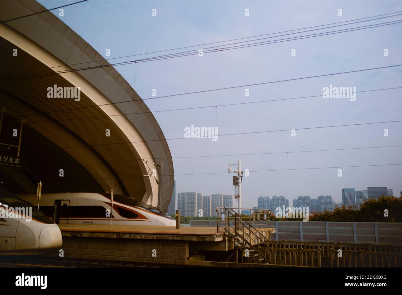 High-speed trains at a modern station with urban skyline in the ...