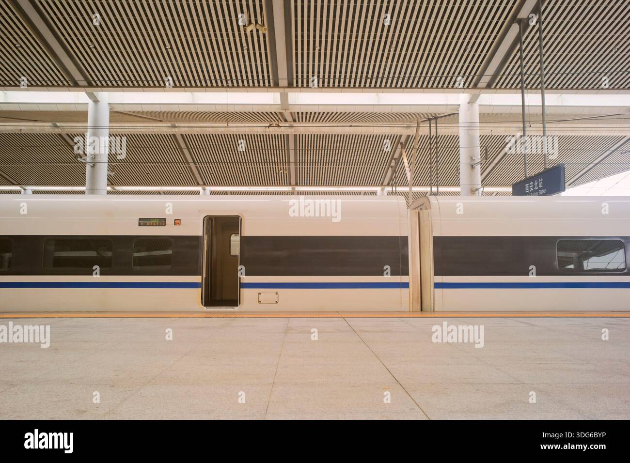 High-speed train at a modern, empty station with open doors and smooth ...