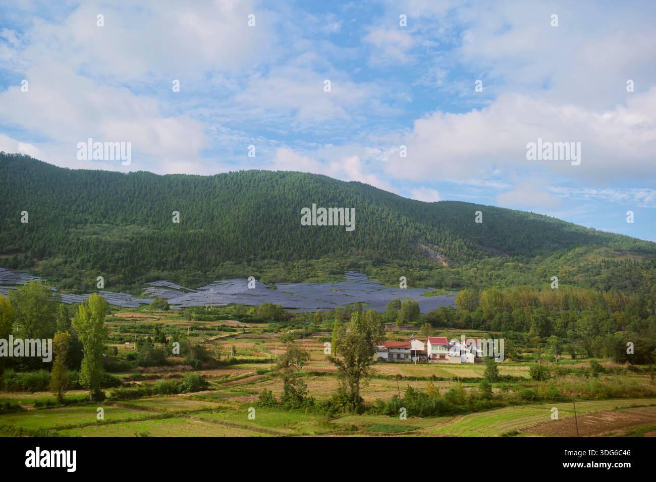 Scenic landscape with green hills, fields, and a house under a blue ...